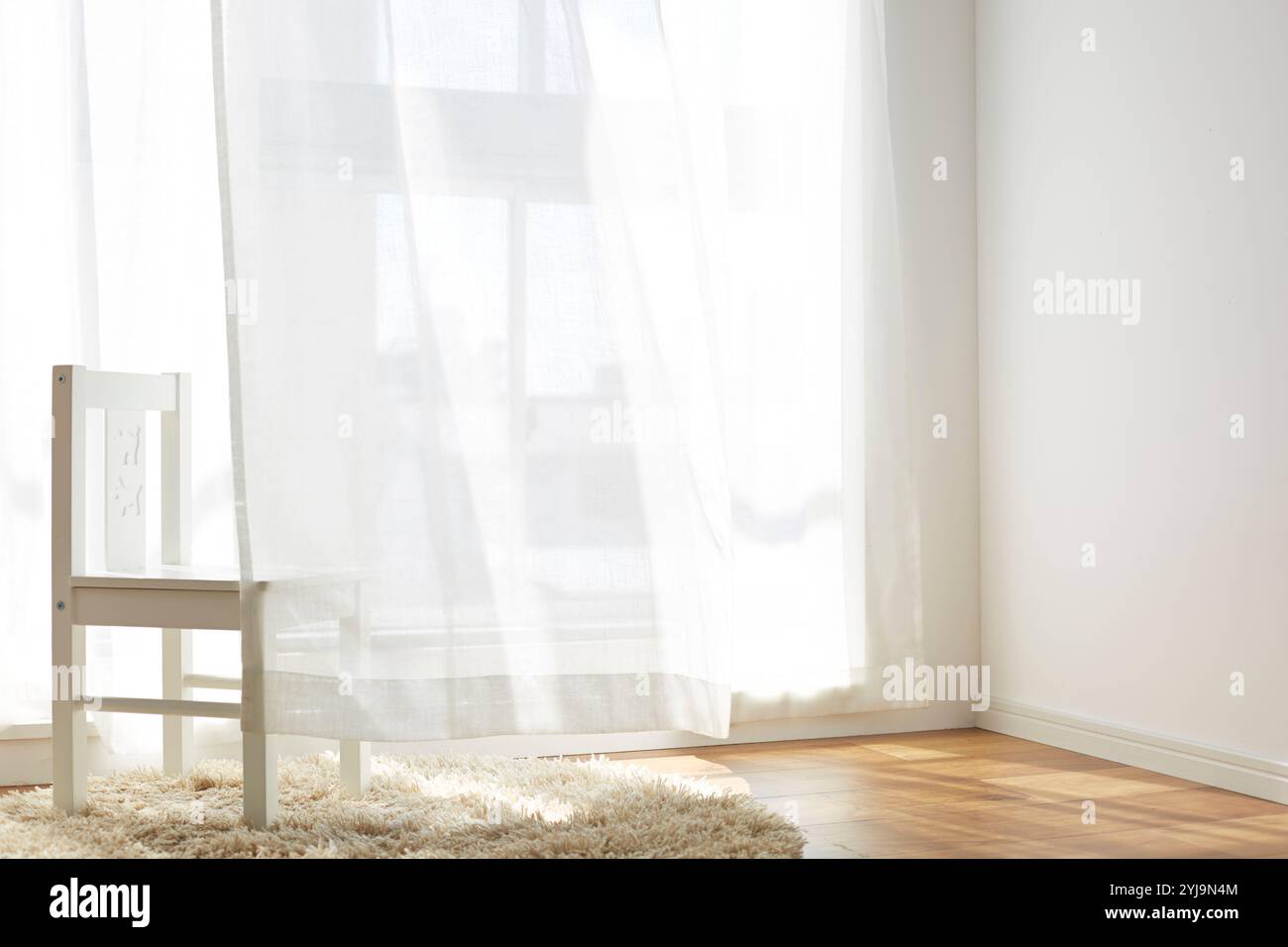 Children's chair on a window sill with beautiful light Stock Photo - Alamy