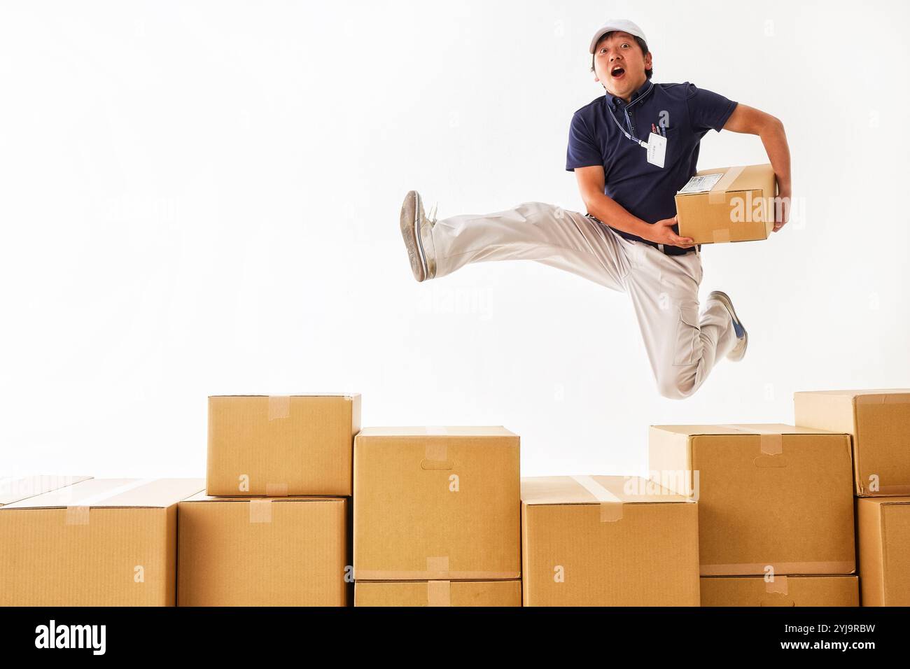 Running delivery man boxes hi-res stock photography and images - Alamy