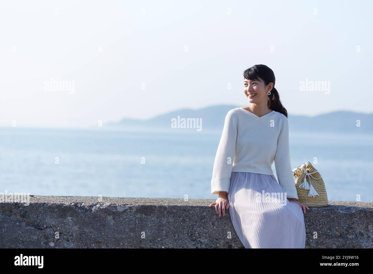 Woman sitting on embankment hi-res stock photography and images - Alamy