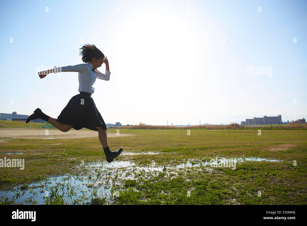 High school girl running on ground Stock Photo - Alamy