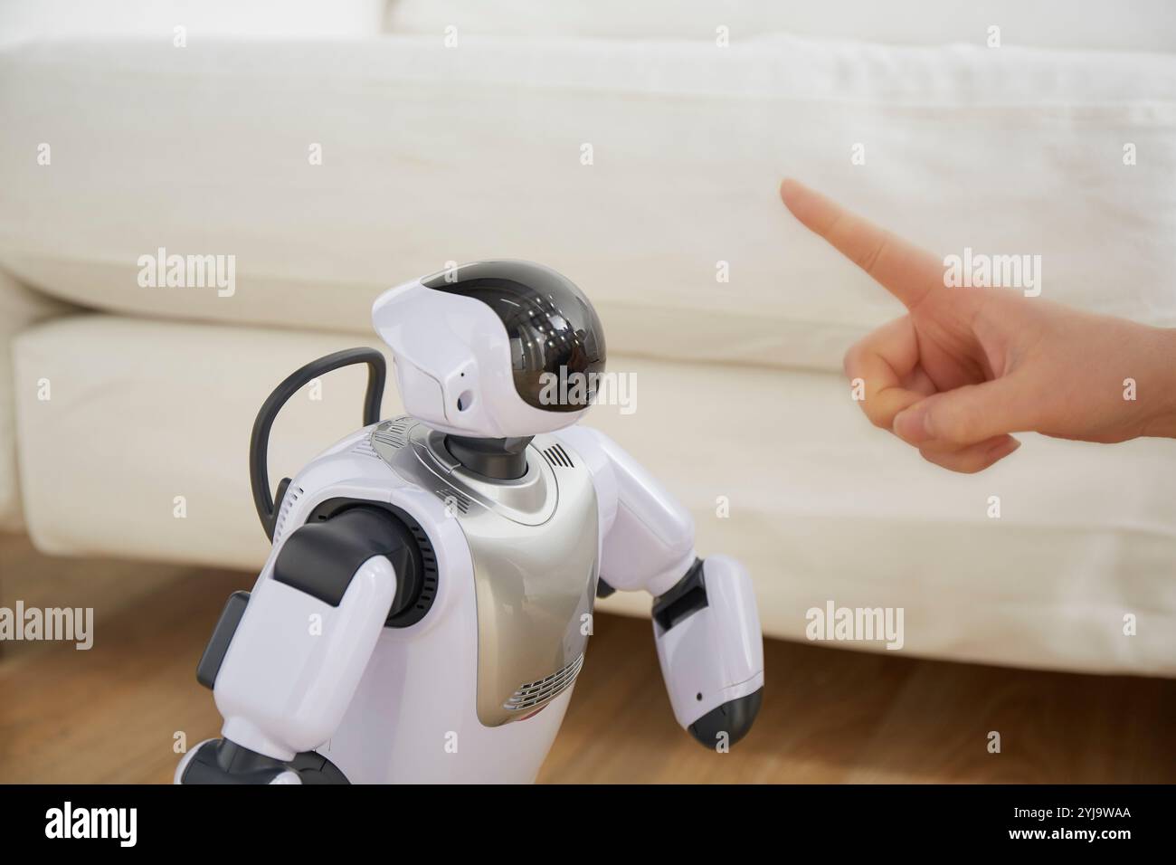 Robot being disciplined by woman Stock Photo - Alamy