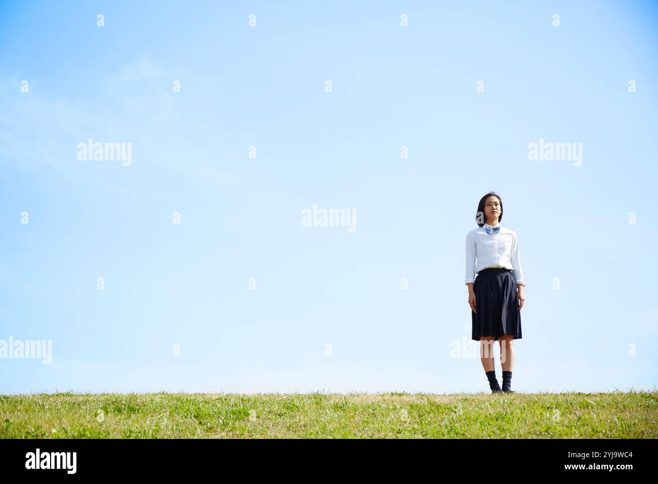 High school girl standing on riverbed staring into distance Stock Photo ...