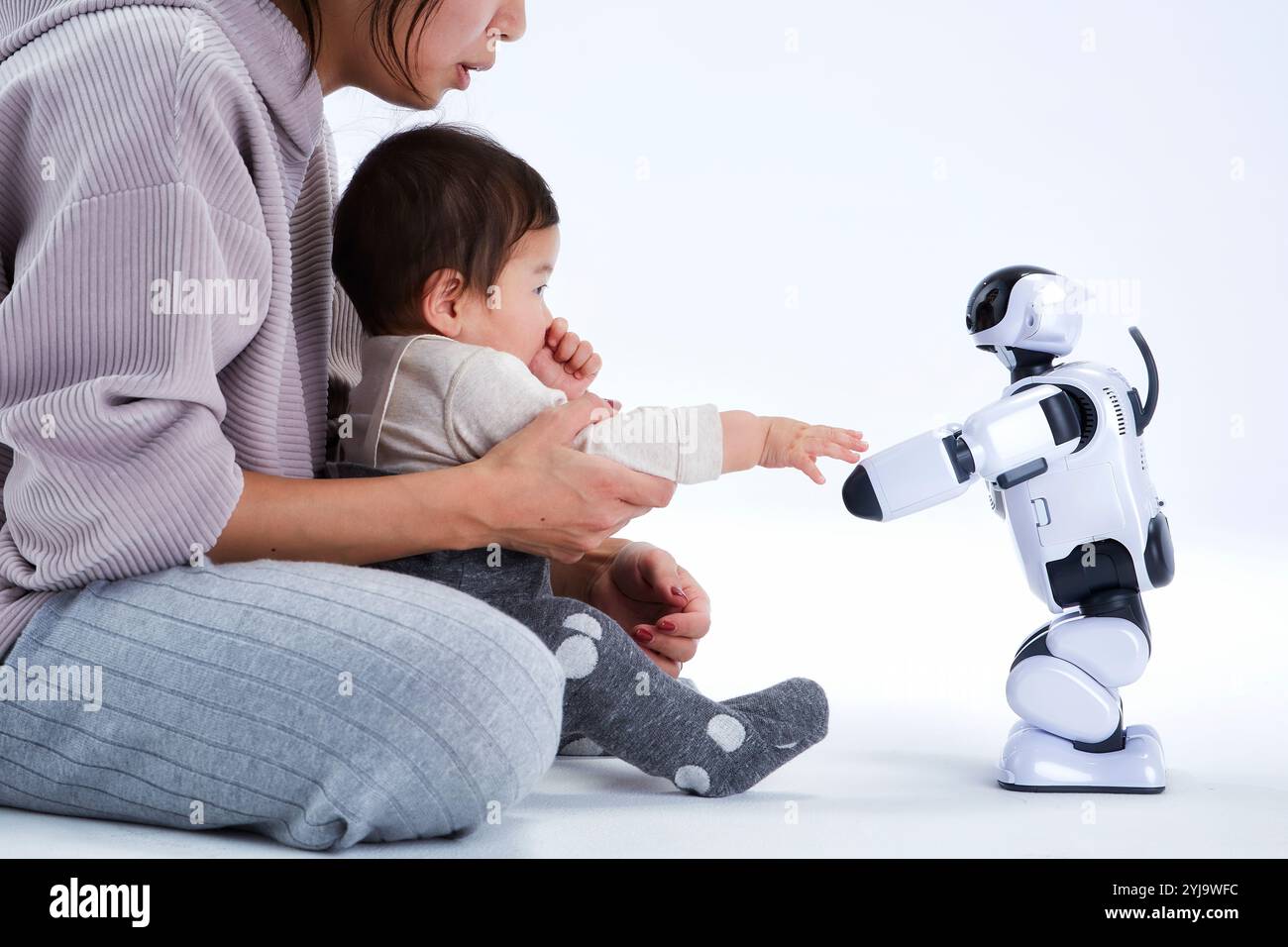 Parent and child and talking robot Stock Photo - Alamy