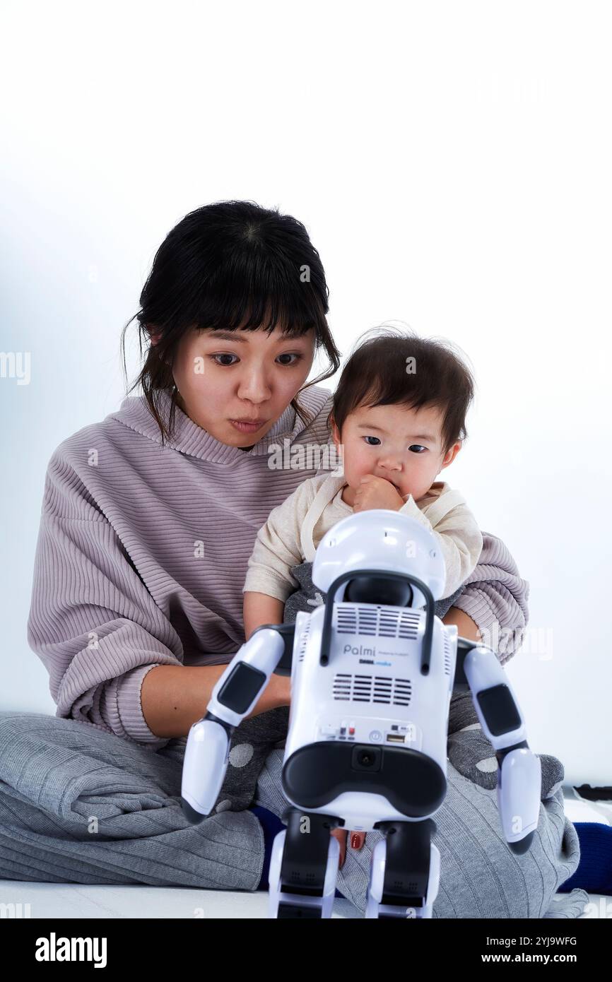 Parent and child and talking robot Stock Photo - Alamy