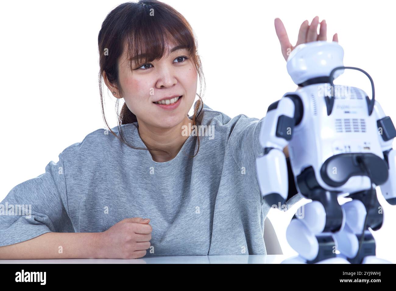 Woman chatting with mini robot Stock Photo - Alamy