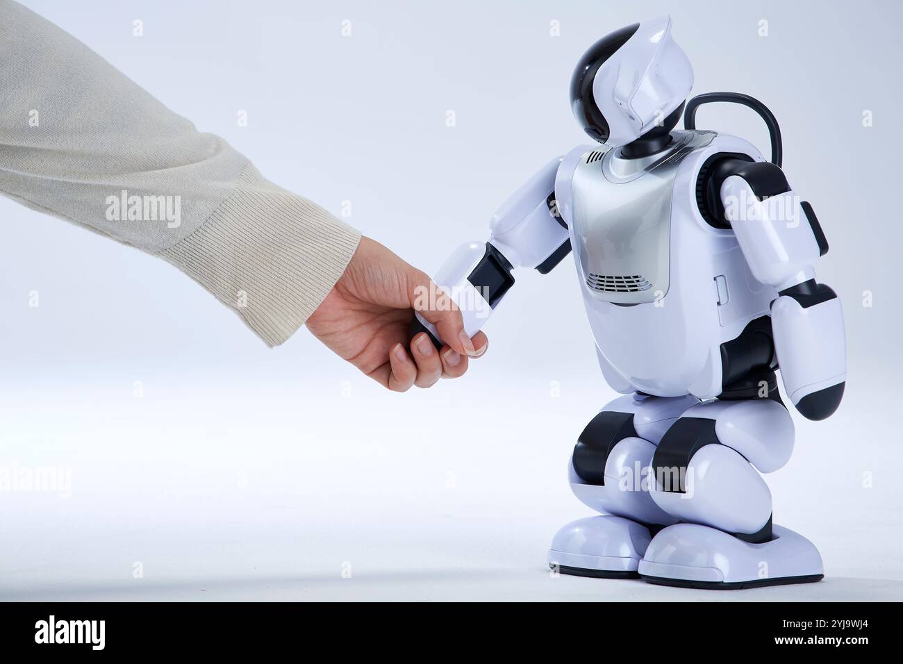 Human hand shaking hands with robot Stock Photo - Alamy
