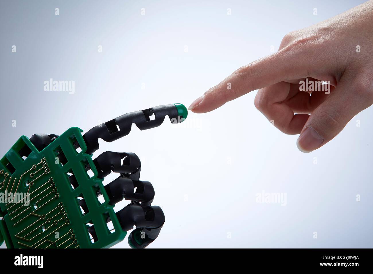 Human and robot pointing fingers together Stock Photo - Alamy