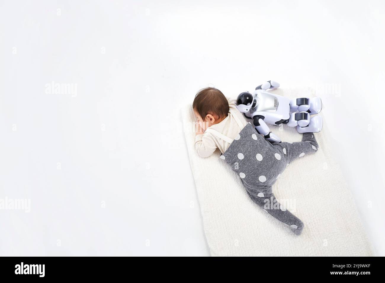 Robot napping with napping baby Stock Photo - Alamy