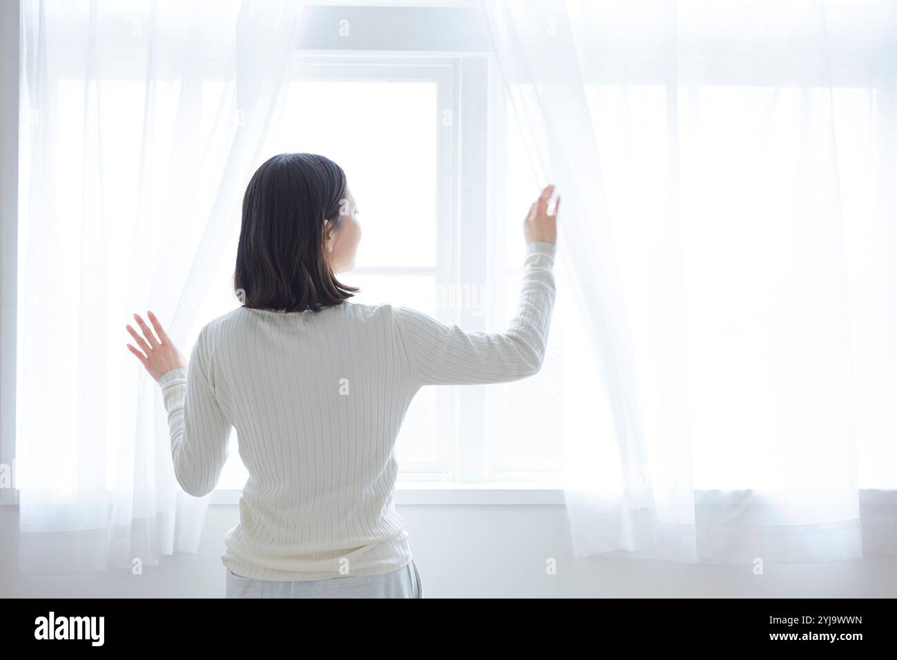 Back view woman opening curtains hi-res stock photography and images ...