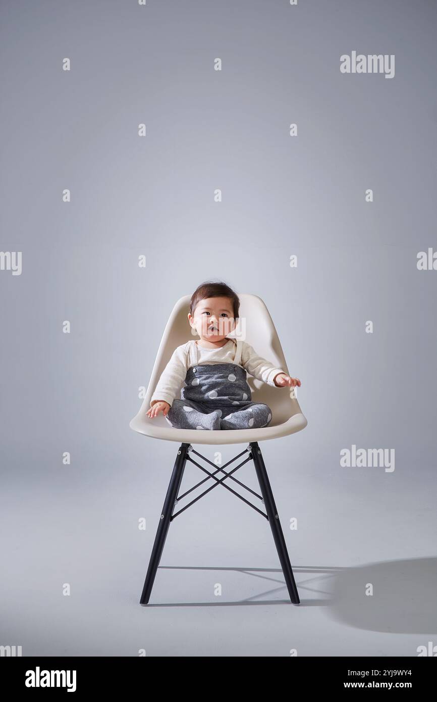 Infant sitting on a chair infant sitting on a chair hi-res stock ...