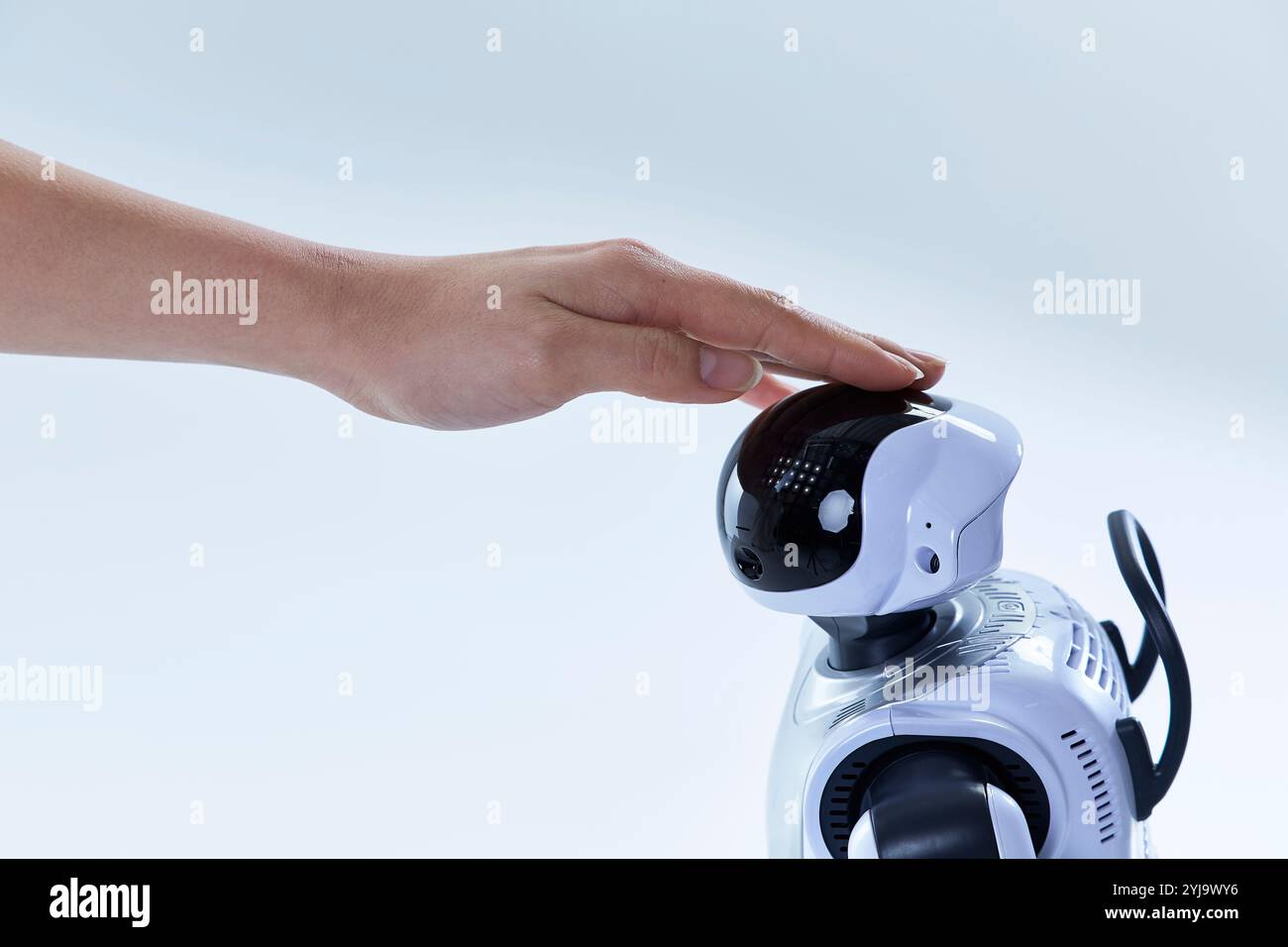 Human hand caressing robot's head Stock Photo - Alamy