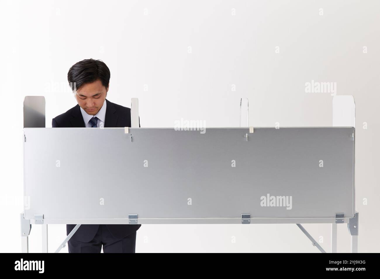 Man in suit using voting registration table Stock Photo - Alamy