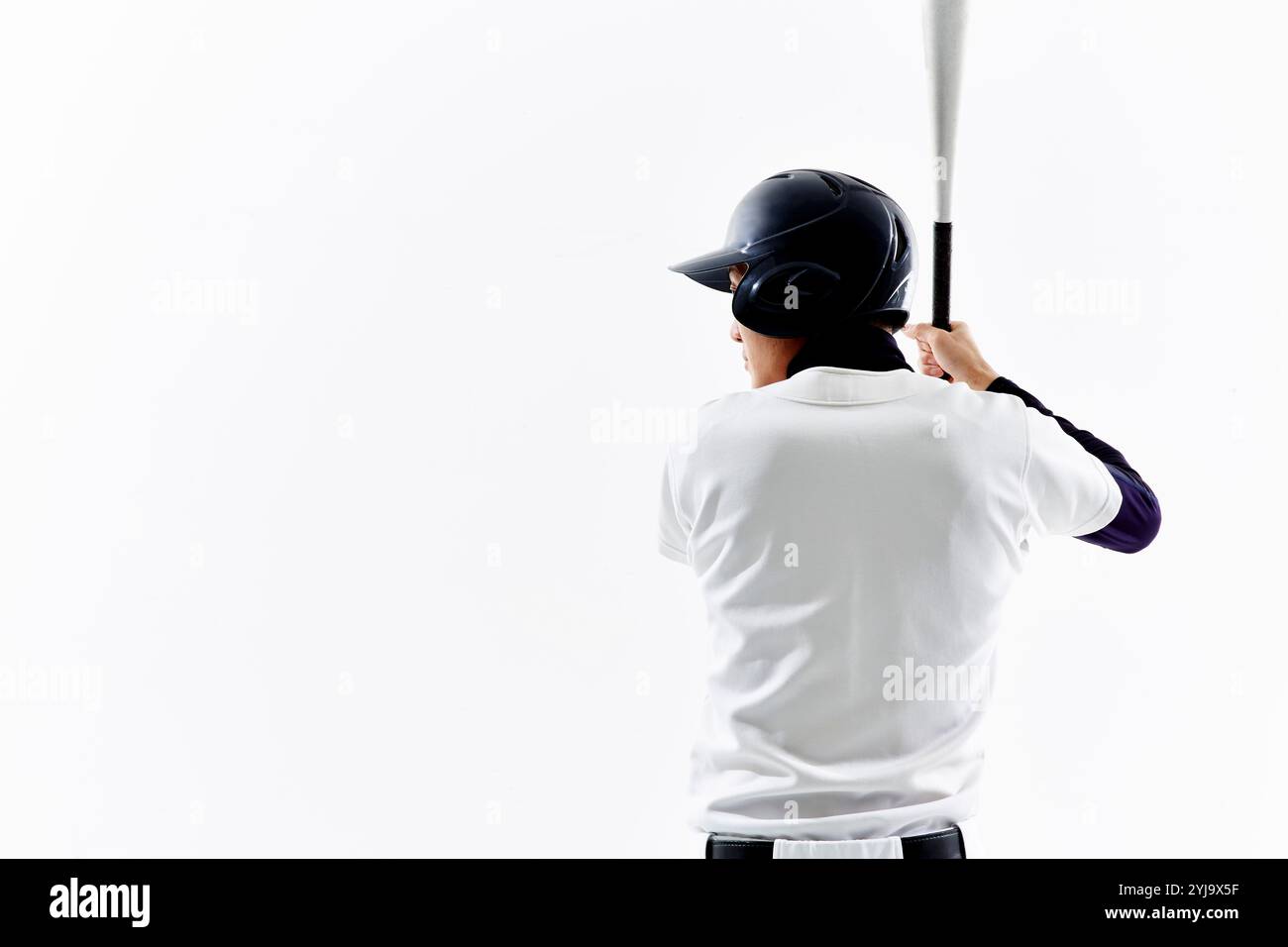 Man in baseball uniform swinging bat Stock Photo - Alamy