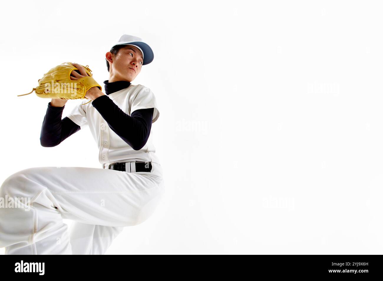 Man in baseball uniform trying to throw ball Stock Photo - Alamy