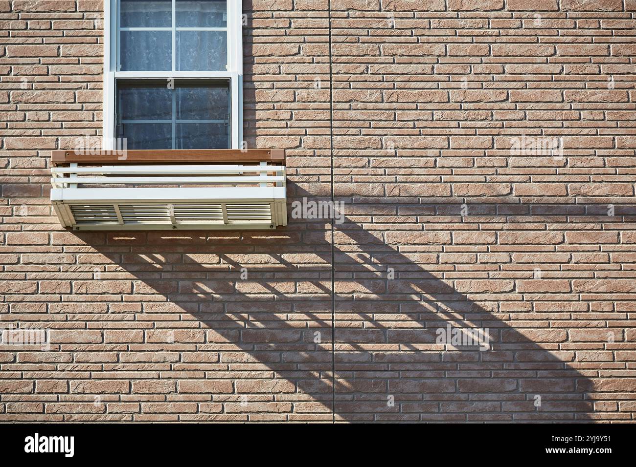 Small window in house with beige brick walls Stock Photo - Alamy