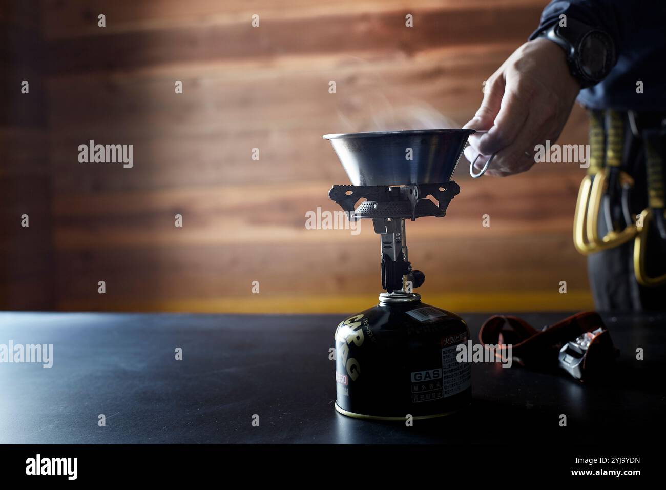 People using a gas stove to heat drinks at a desk inside the hut Stock ...
