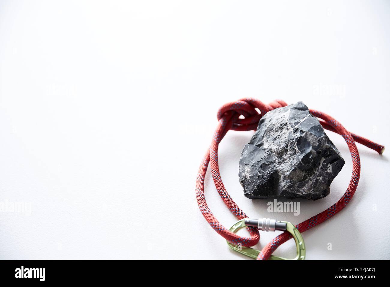 Rope and stones connected to carabiner Stock Photo - Alamy
