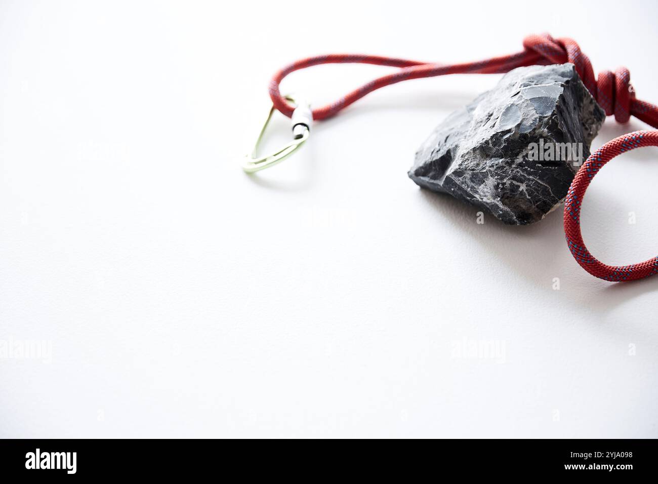 Rope and stones connected to carabiner Stock Photo - Alamy