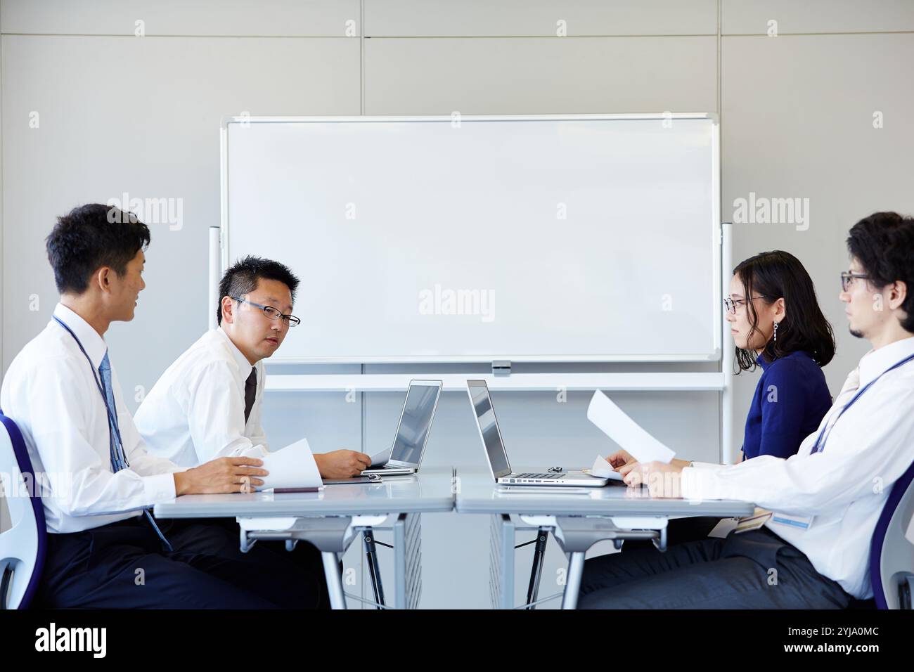 Employees sitting face to face and discussing with each other Stock ...