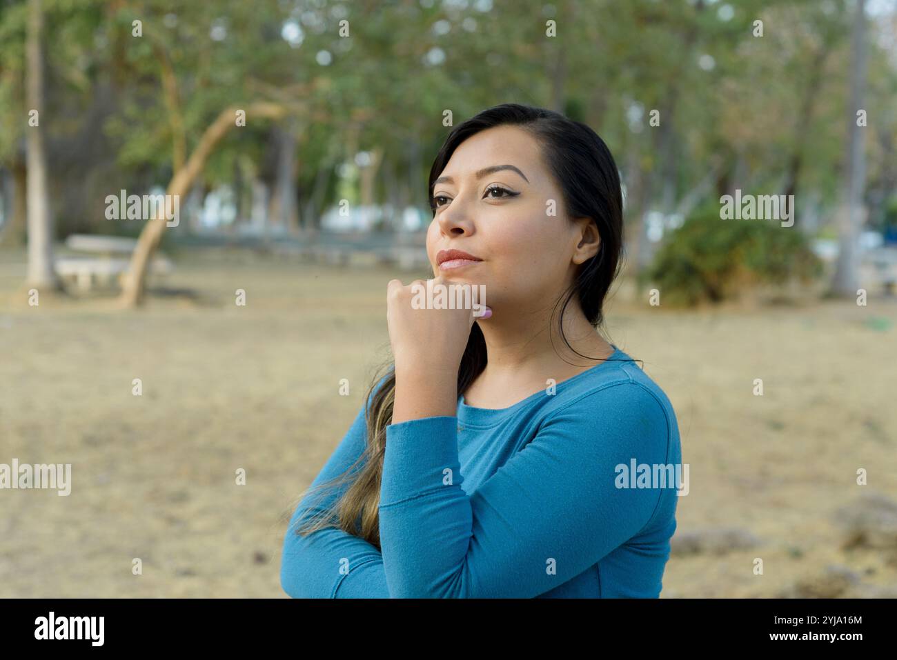 Woman in a public park with an attitude of preoccupation, pensive Stock ...