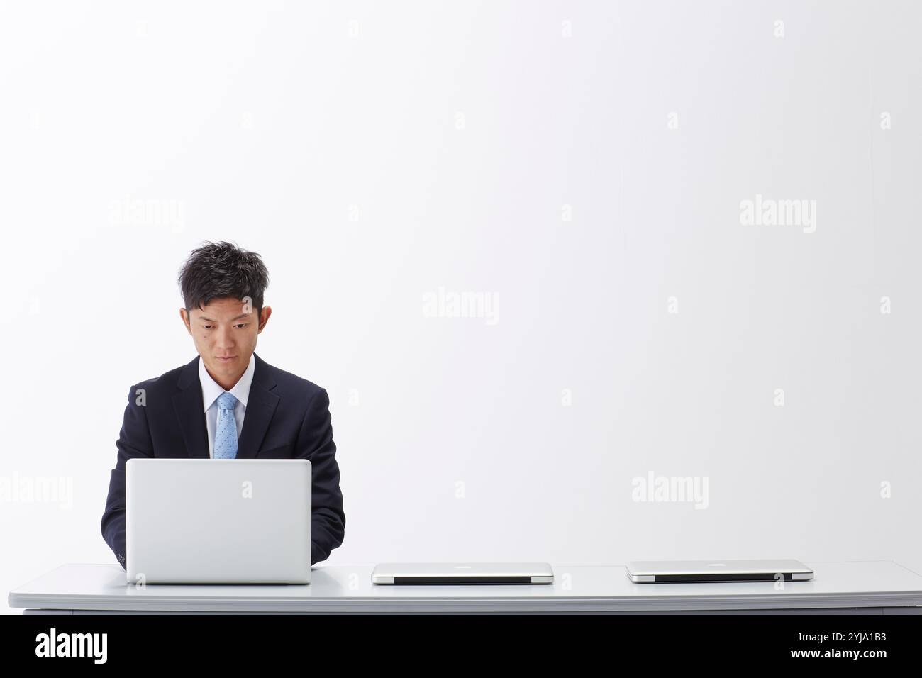 Man sitting alone in front of computer Stock Photo - Alamy