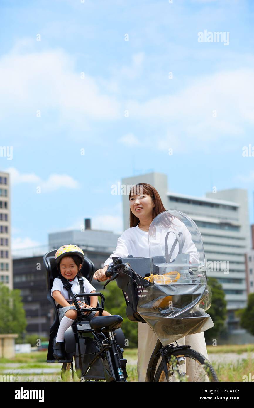 Mother taking her child out on a bicycle Stock Photo - Alamy