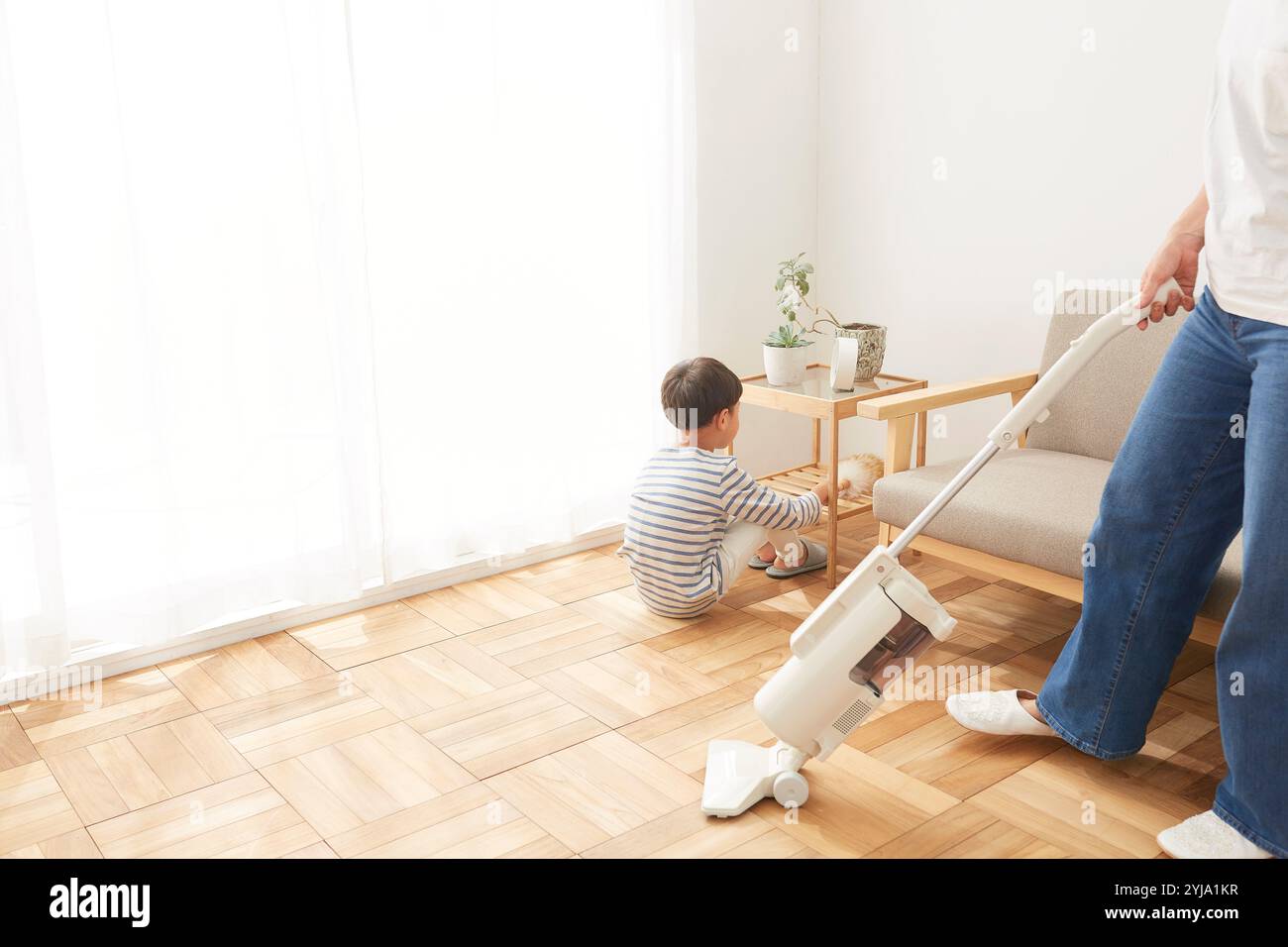 Parent and child cleaning the living room Stock Photo - Alamy