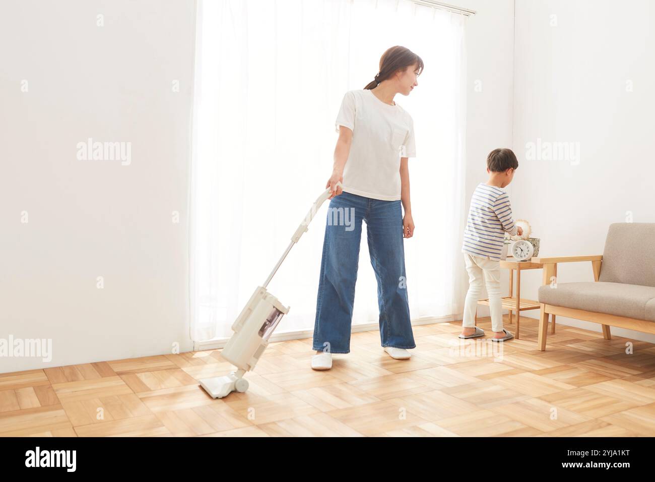 Parent and child cleaning the living room Stock Photo - Alamy