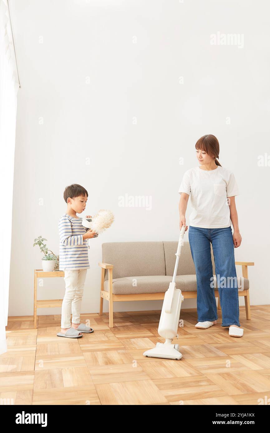 Parent and child cleaning the living room Stock Photo - Alamy