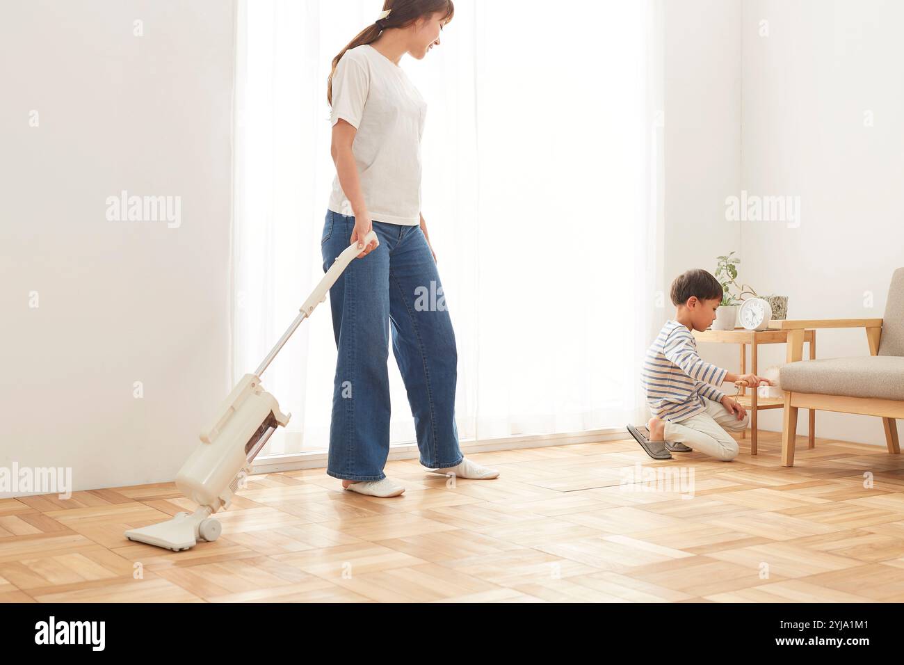 Parent and child cleaning the living room Stock Photo - Alamy