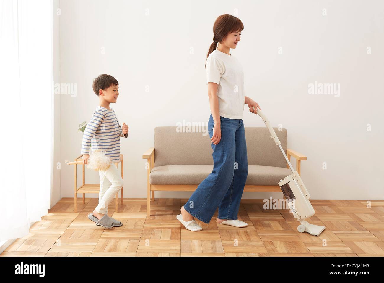 Parent and child cleaning the living room Stock Photo - Alamy