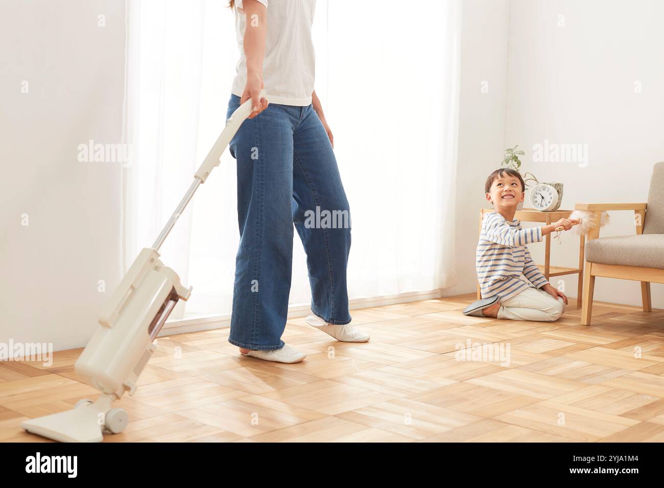 Parent and child cleaning the living room Stock Photo - Alamy
