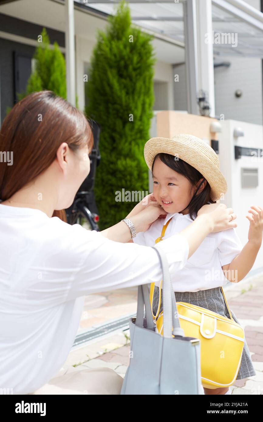 Parent and child getting ready in front of the house Stock Photo - Alamy