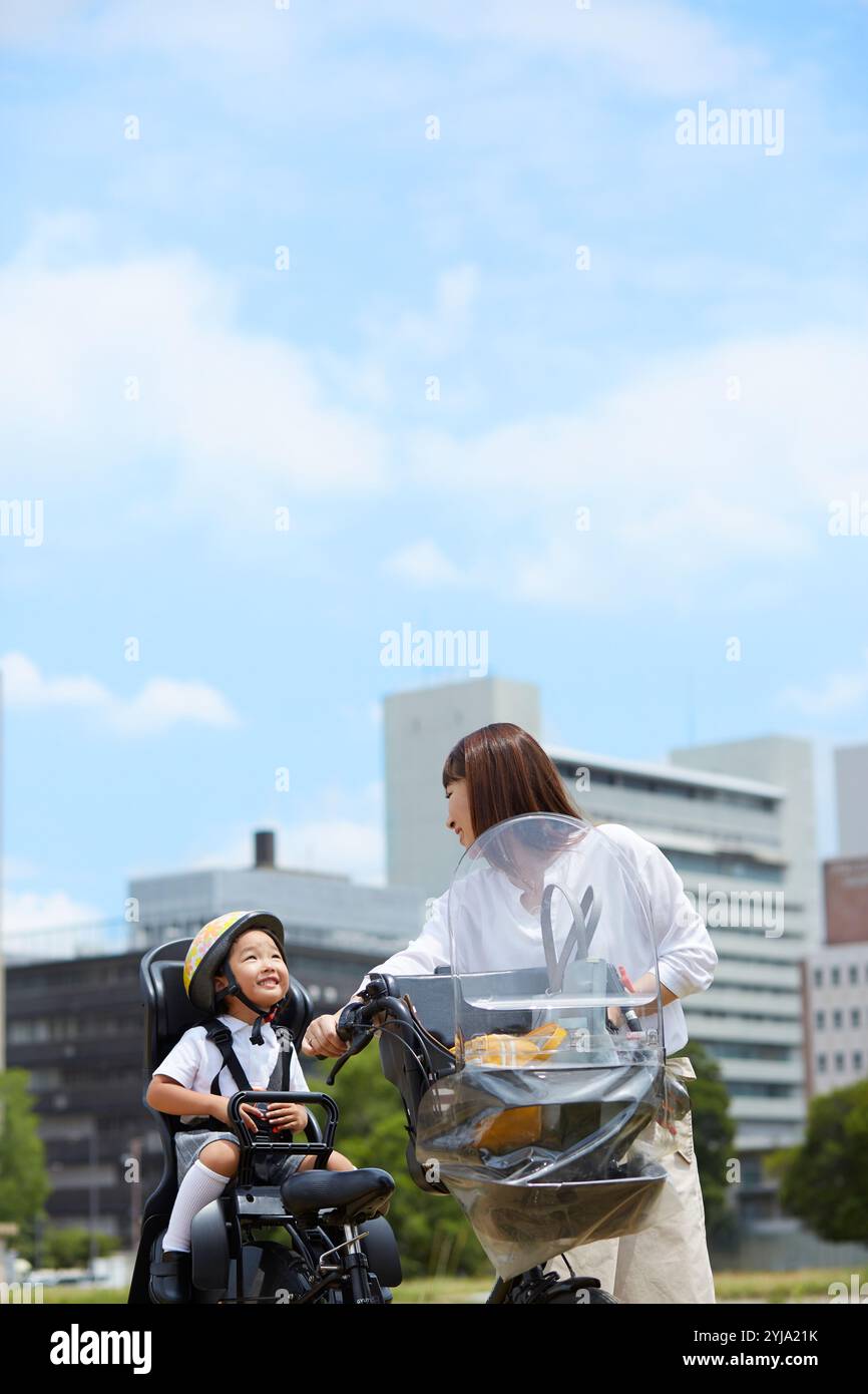 Mother taking her child out on a bicycle Stock Photo - Alamy