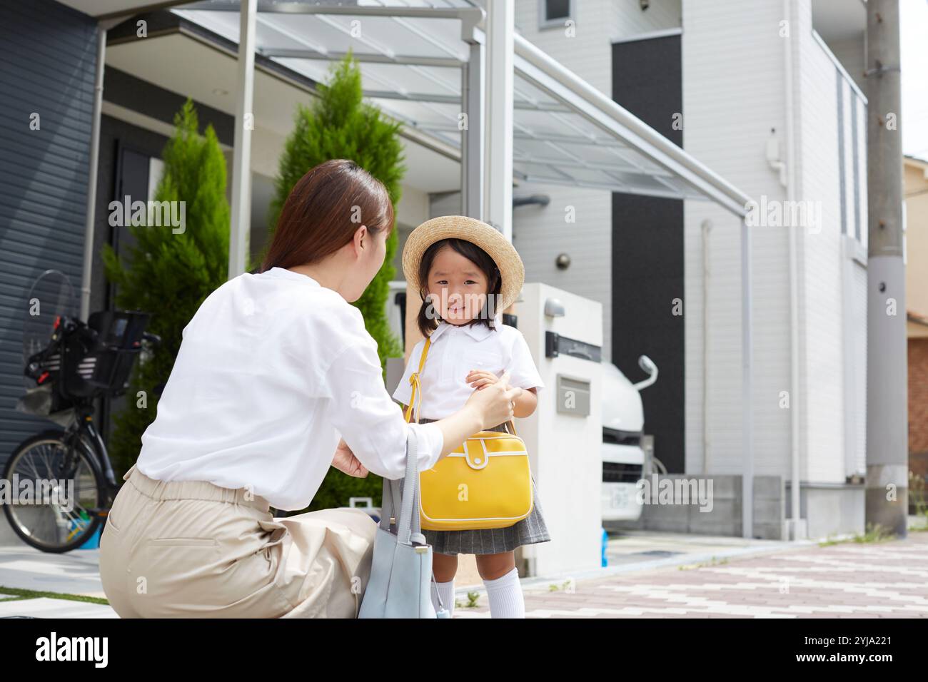 Parent and child getting ready in front of the house Stock Photo - Alamy