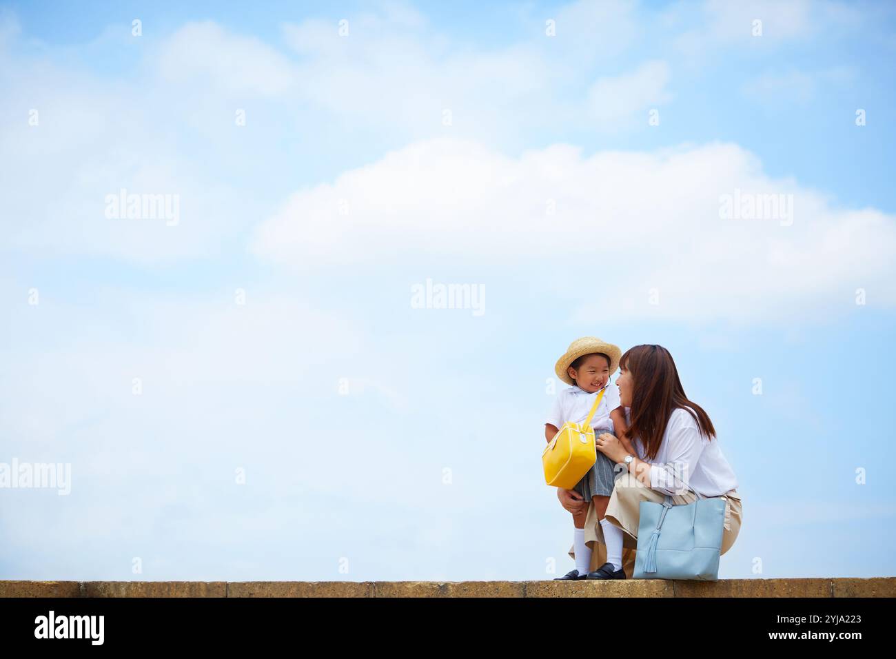 Parent and child talking on high ground Stock Photo - Alamy