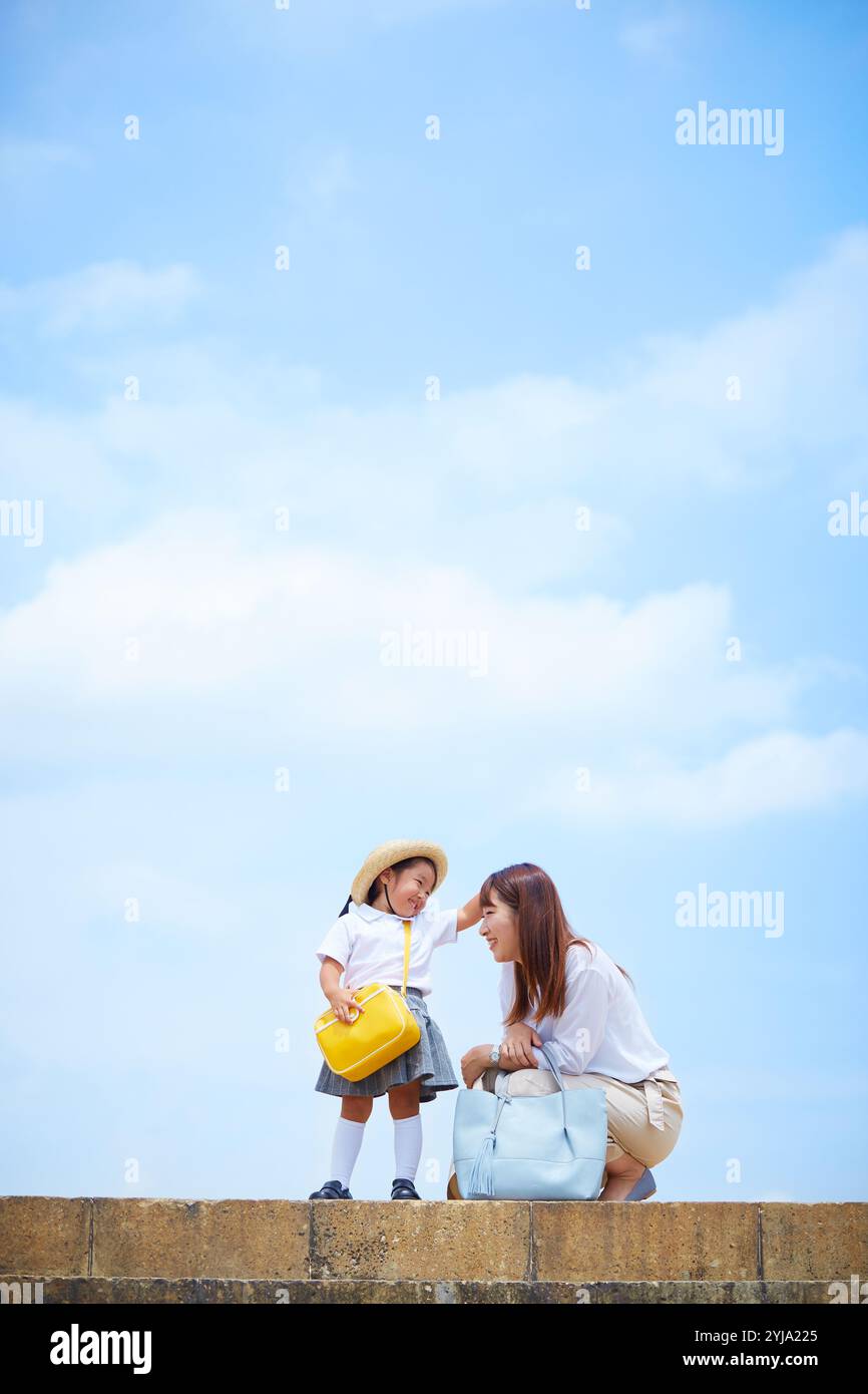 Parent and child talking on high ground Stock Photo - Alamy