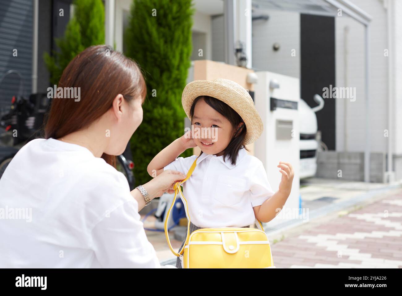 Parent and child getting ready in front of the house Stock Photo - Alamy