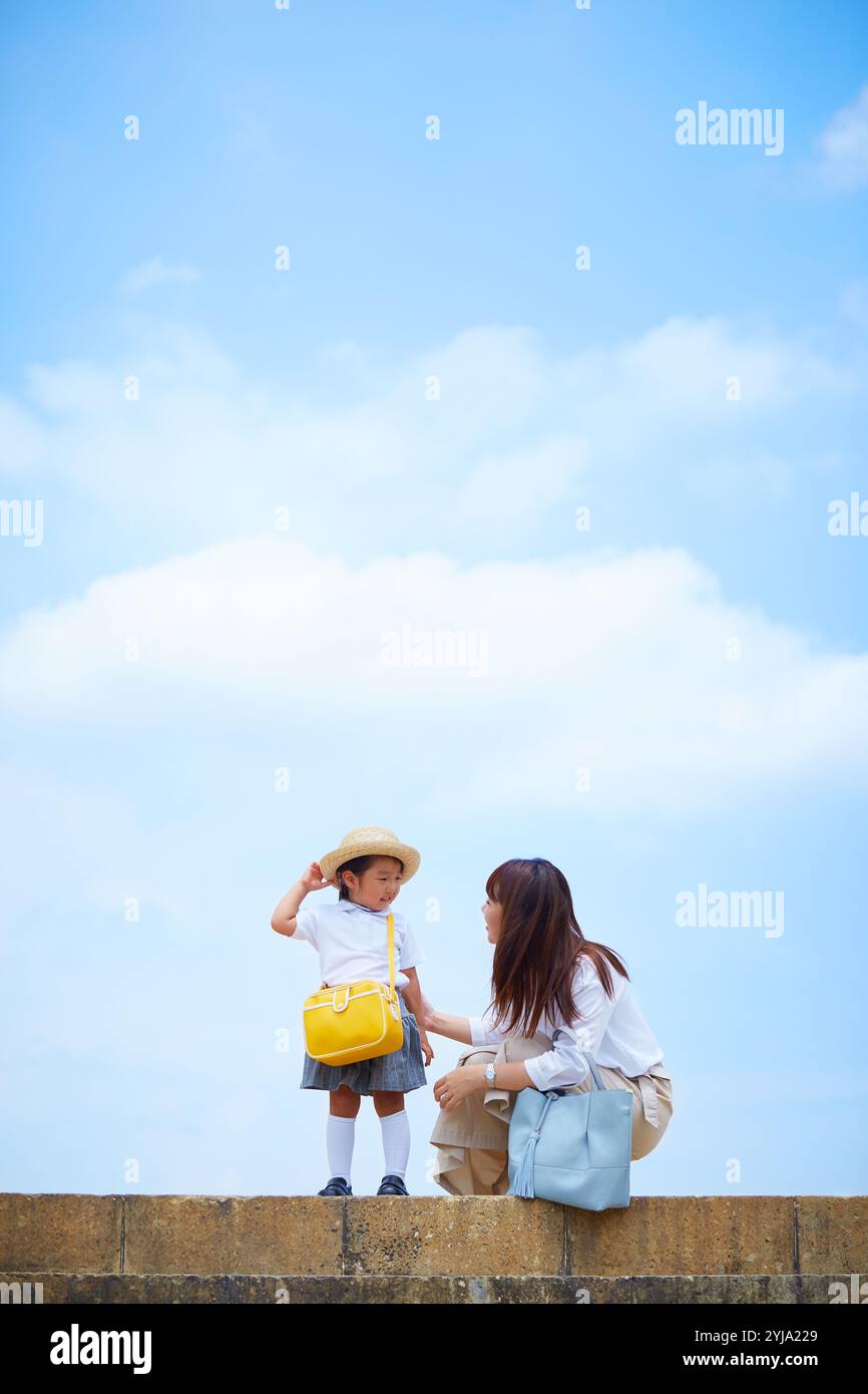 Parent and child talking on high ground Stock Photo - Alamy
