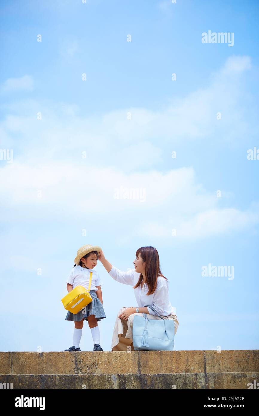 Parent and child talking on high ground Stock Photo - Alamy