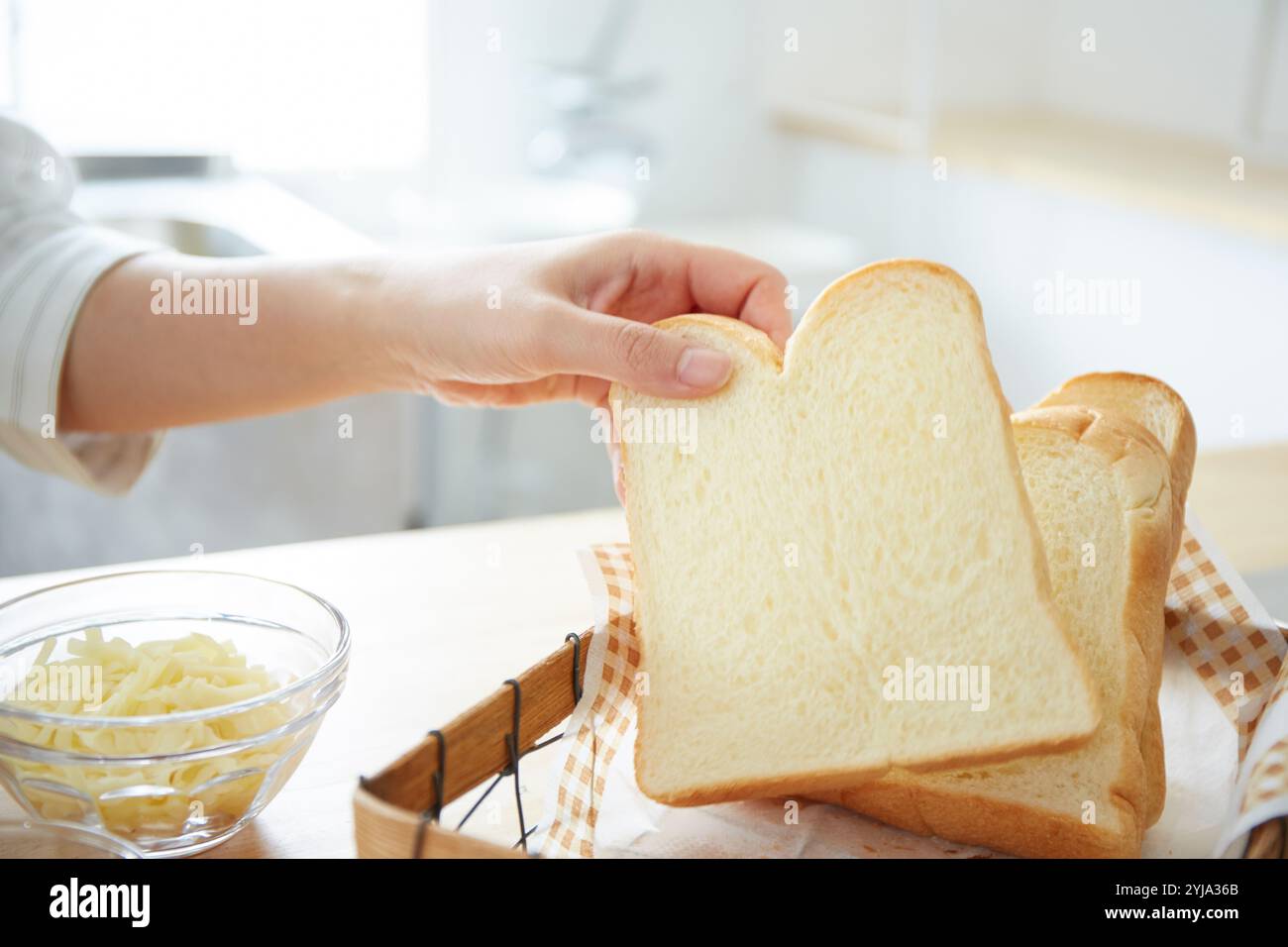 Hand taking piece bread hi-res stock photography and images - Alamy
