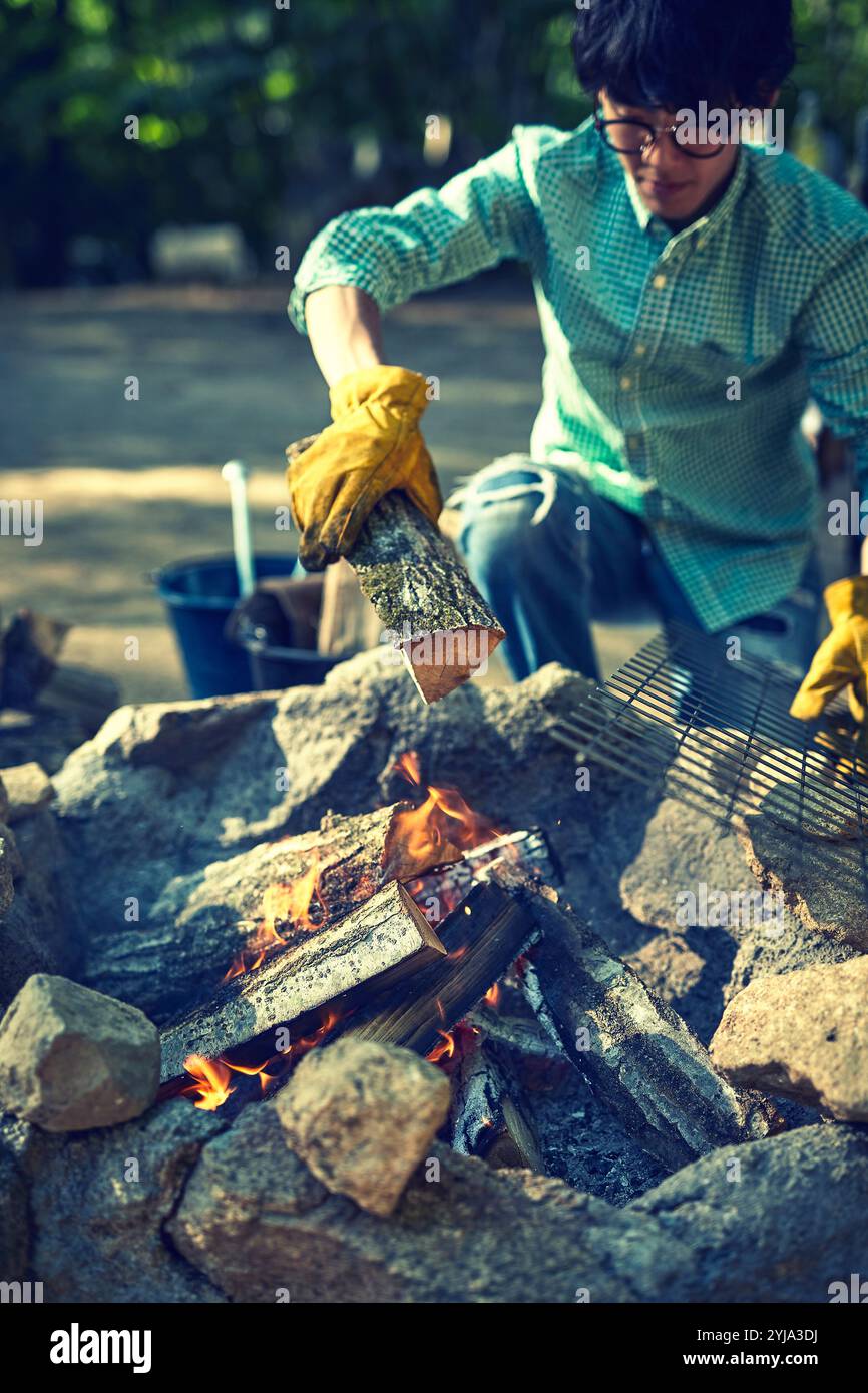 Man building a fire in camp Stock Photo - Alamy