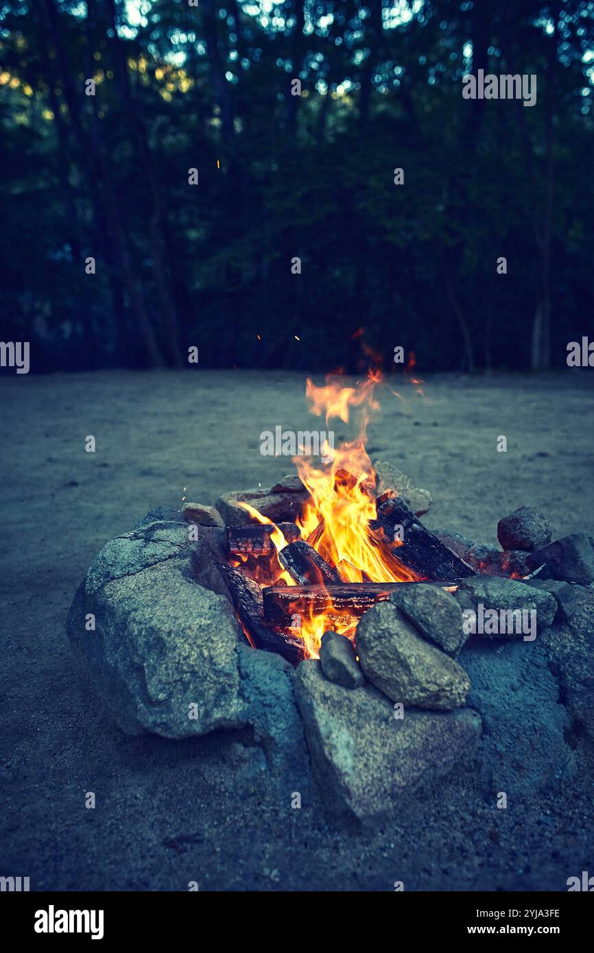 Building a bonfire at a campsite Stock Photo - Alamy