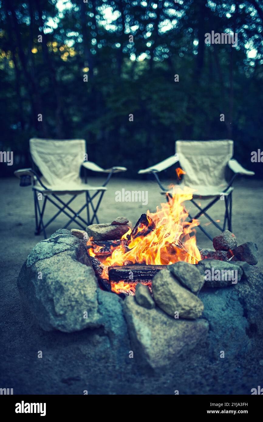 Building a bonfire at a campsite Stock Photo - Alamy