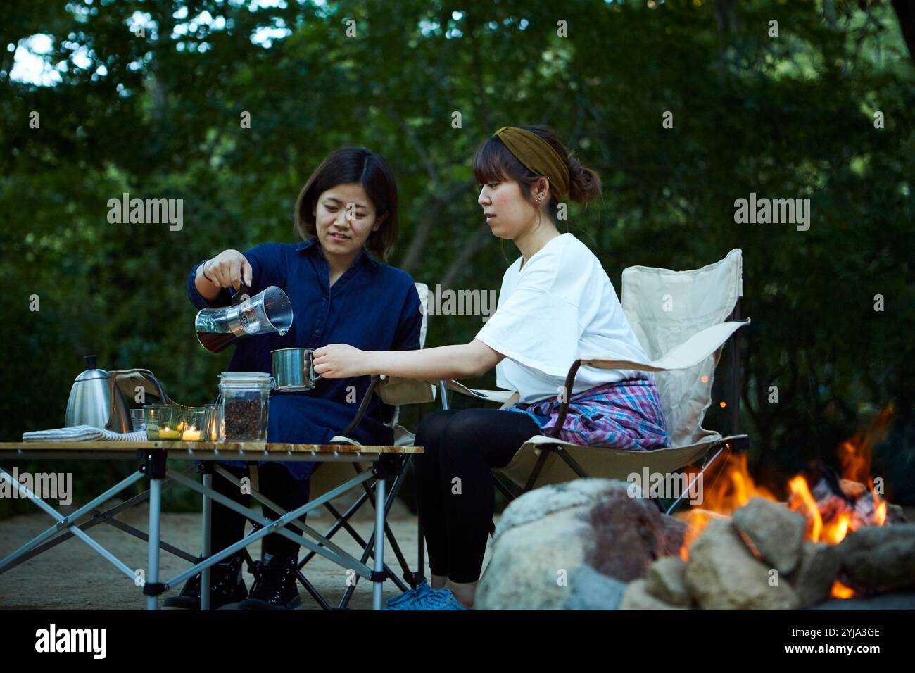 Two people dripping coffee outside Stock Photo - Alamy
