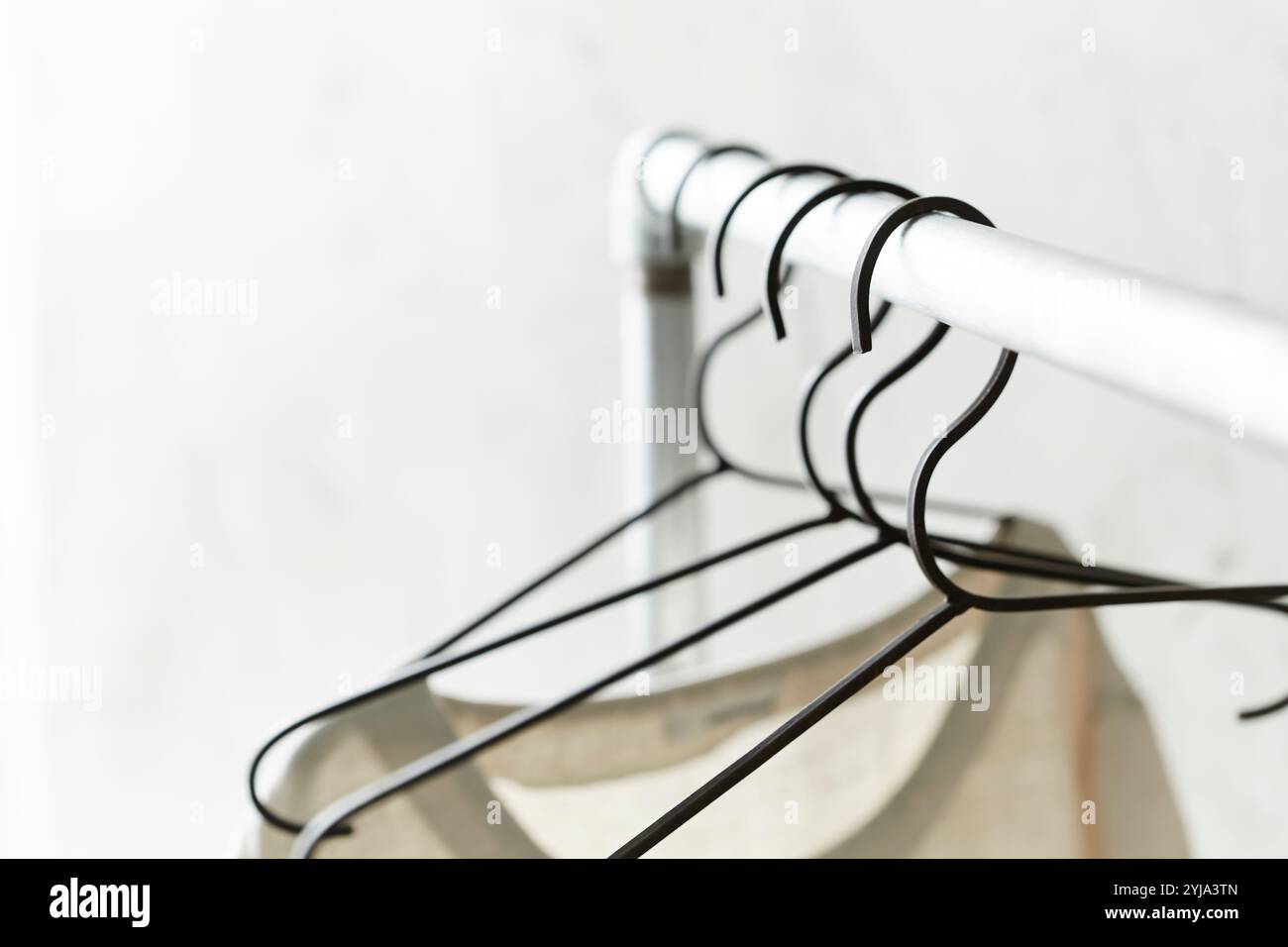 Hangers and clothes on silver rack Stock Photo - Alamy