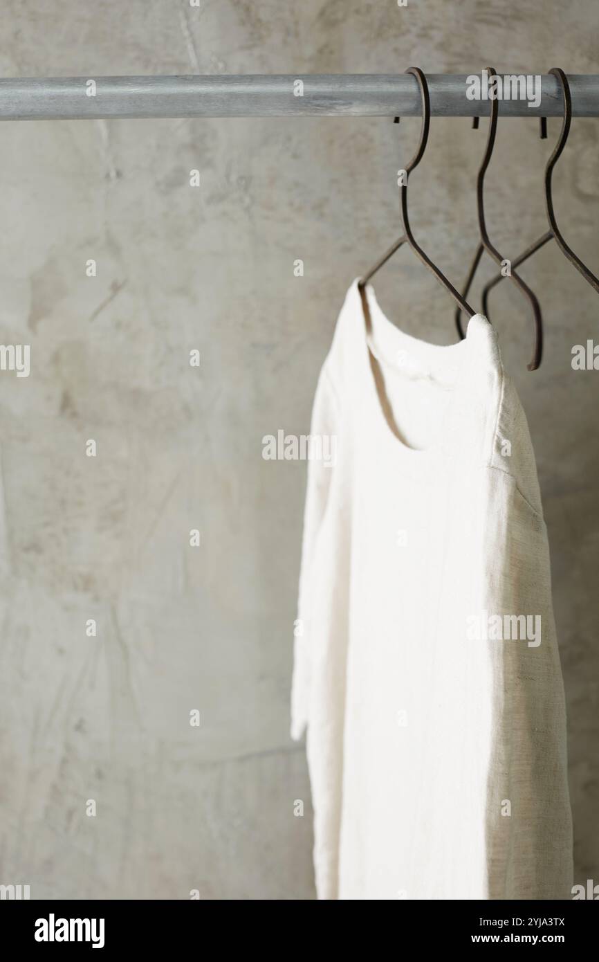 Hangers and clothes on silver rack Stock Photo - Alamy