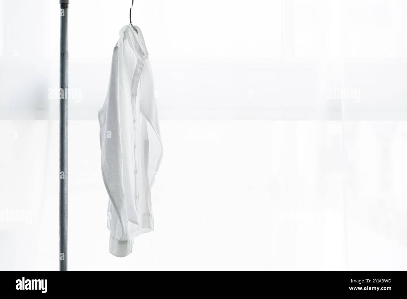 Hangers and clothes on silver rack Stock Photo - Alamy