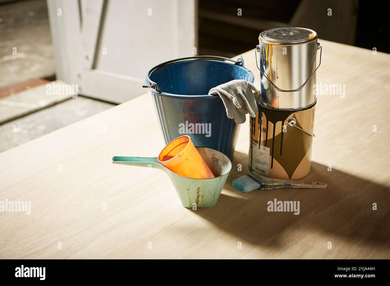 Paint can and bucket on the work bench Stock Photo - Alamy