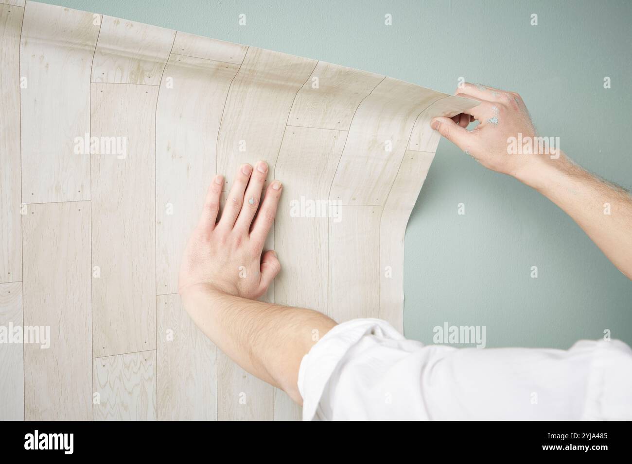 Applying wallpaper to wall hi-res stock photography and images - Alamy